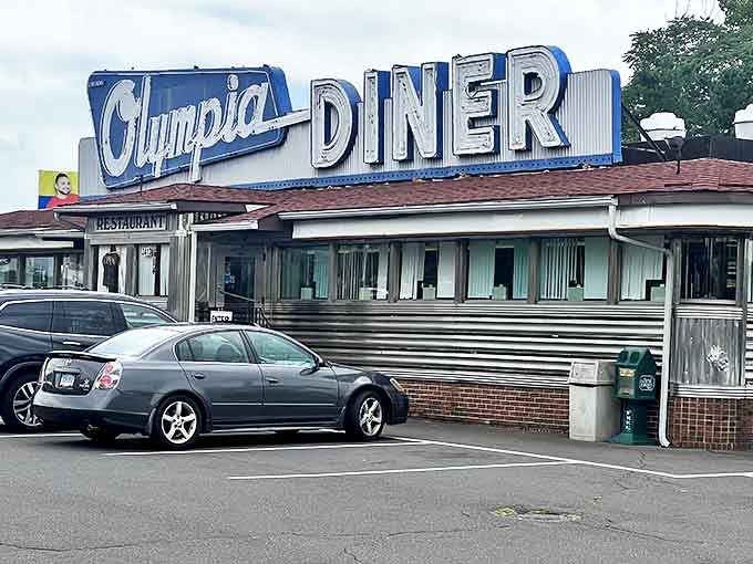 The Olympia Diner stands proud with its vintage blue and silver styling. A landmark where generations have gathered for eggs and gossip.
