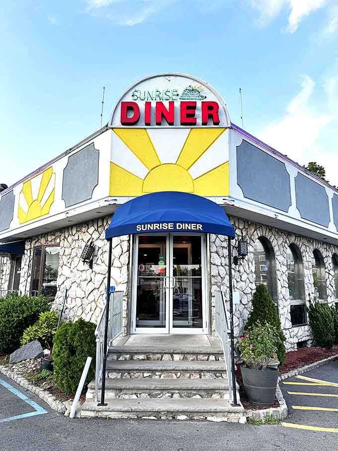 The Sunrise Diner's stone facade and sunburst sign promise the kind of breakfast that makes getting out of bed worthwhile.