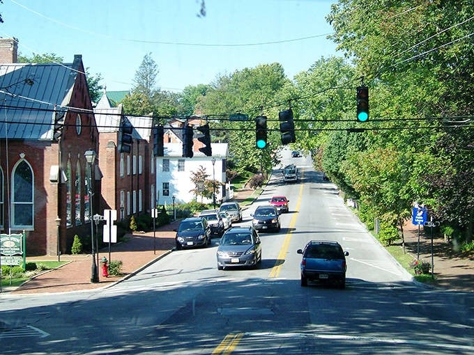 Tree-lined streets create natural tunnels of tranquility where every step feels like walking through living history.