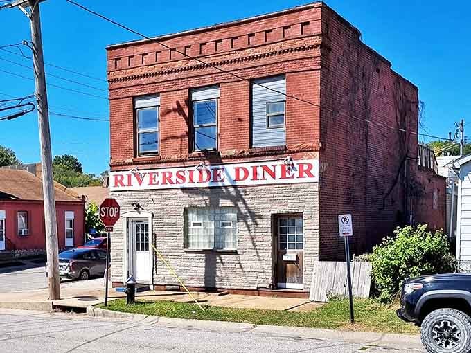The two-tone stonework of Riverside Diner stands as proudly as its reputation for gravy that could solve world peace.