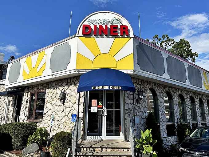 Like a culinary lighthouse, Sunrise Diner's cheerful exterior signals safe harbor for empty stomachs and coffee addicts alike.