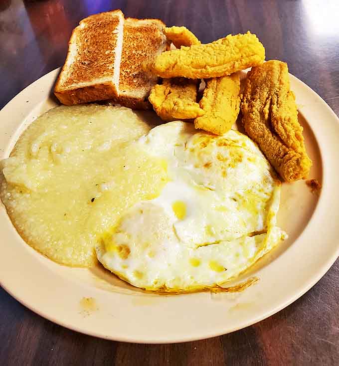 Sunny-side up eggs, golden grits, and crispy fried catfish&mdash;a breakfast trinity that proves New Orleans knows morning meals aren't just for tourists.