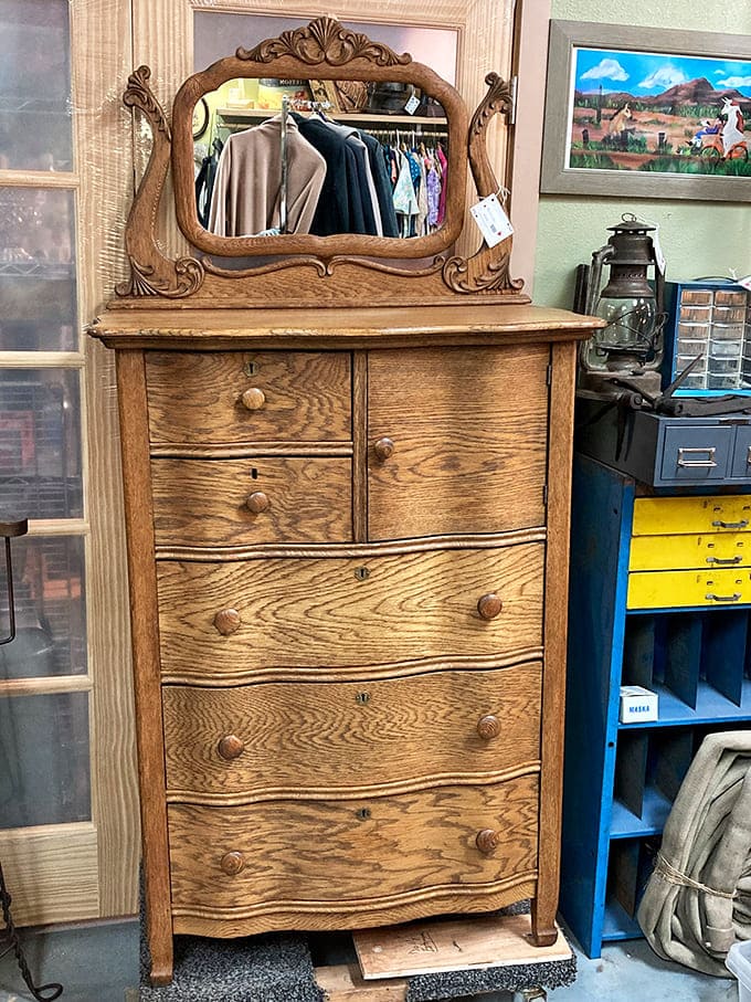 This oak dresser has witnessed more morning routines than a barista at the busiest coffee shop in Anchorage. The mirror still reflects stories from another era.