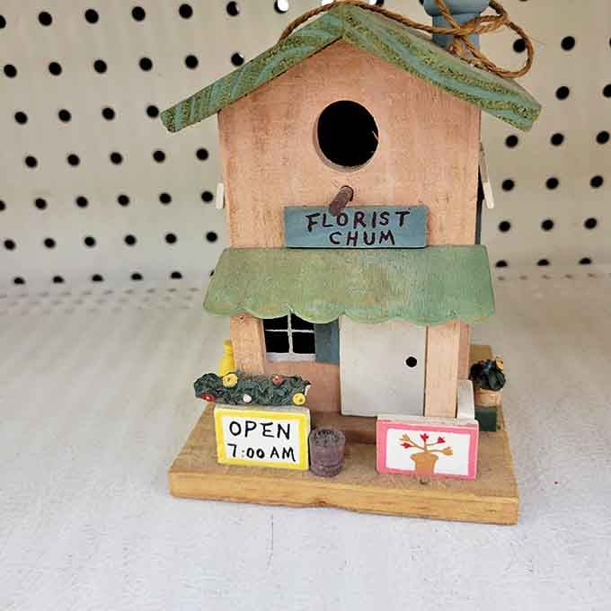 This charming "Florist Chum" birdhouse proves one shopper's castoff becomes another's garden centerpiece—whimsy at its most affordable.