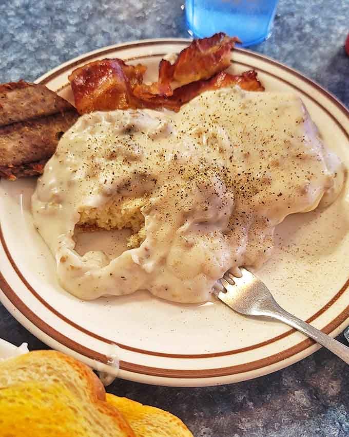 Biscuits swimming in peppery sausage gravy &ndash; the kind of breakfast that makes you want to hug the cook and take a nap simultaneously.