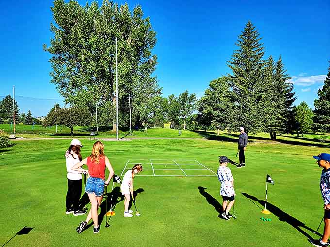 At Black Sands Golf Course, young players learn the game amid towering pines, where patience grows alongside putting skills.