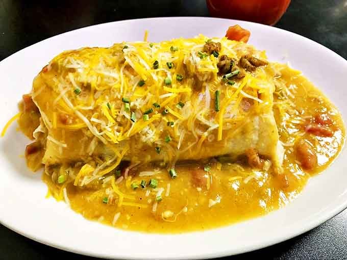 Behold the legendary breakfast burrito &ndash; where cheese cascades over a perfectly griddled tortilla like a yellow waterfall of morning happiness.