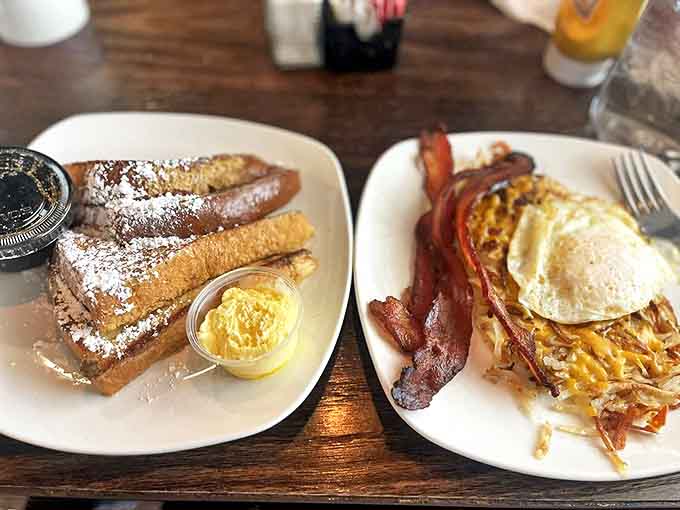 French toast dusted with powdered sugar alongside eggs and bacon&mdash;breakfast's holy trinity assembled on one plate of perfection.
