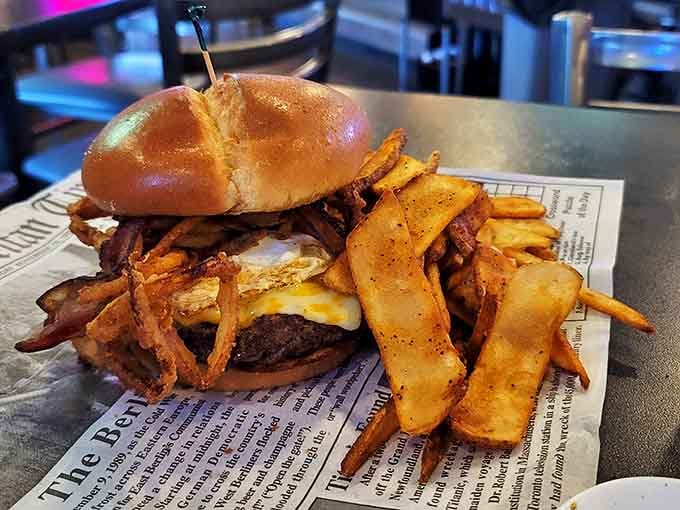 This isn't just a burger; it's an architectural marvel of beef, bacon, and cheese that requires structural engineering skills just to take the first bite.