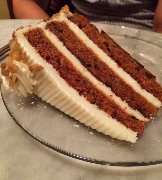 Three perfect layers of carrot cake separated by cream cheese frosting that could make a pastry chef weep with joy.