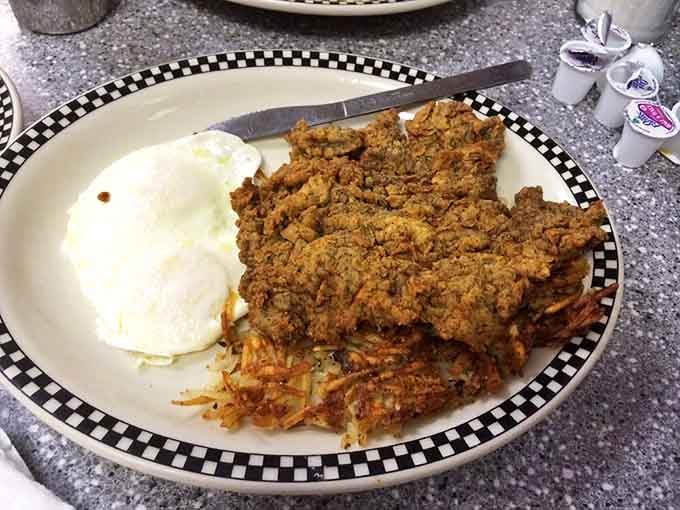 Behold the holy grail of Texas cuisine—a chicken fried steak that's more crispy coating than plate, with mashed potatoes standing by for moral support.