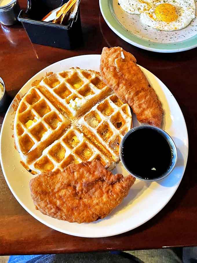 Golden waffle meets crispy fried chicken in a breakfast duet that would make Mozart weep. The maple syrup awaits its starring role in this morning symphony.