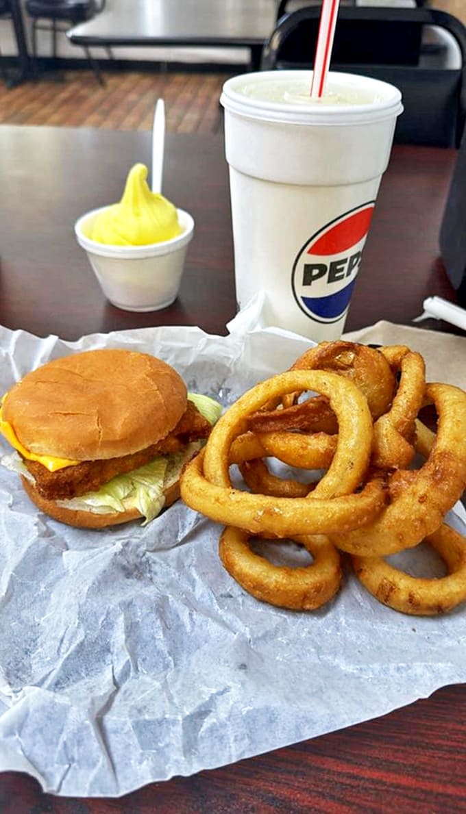 The holy trinity of fast food perfection: a golden cheeseburger, crispy onion rings, and a Pepsi tall enough to quench a Midwestern summer thirst.
