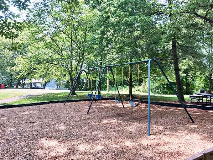 Remember when playgrounds were simple pleasures? This nostalgic swing set waits patiently under shade trees for the next generation of daydreamers.