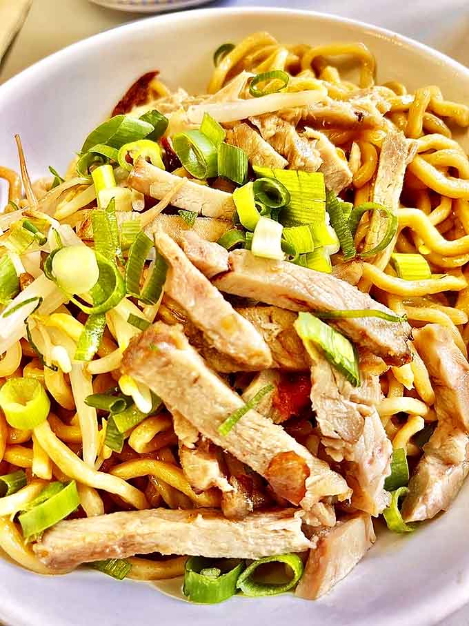 The legendary dry mein&mdash;chewy noodles, savory char siu, and fresh green onions. This isn't just a meal; it's the reason people set their alarms early.