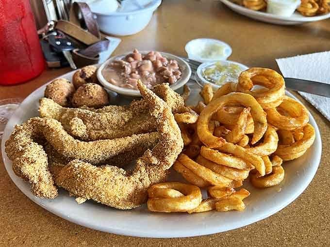 Behold the golden-fried catfish that would make Huckleberry Finn abandon his raft. Crispy cornmeal coating outside, tender flaky goodness inside, with curly fries that demand attention.
