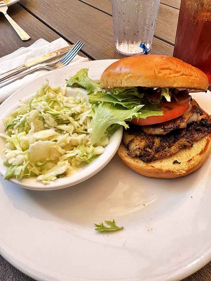 The legendary grouper sandwich arrives with coleslaw so fresh it might have been harvested while you were deciding what to order.