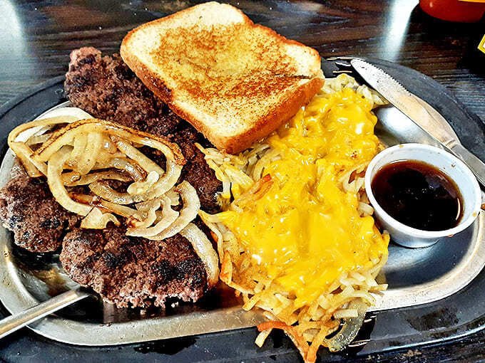 Hamburger steak with grilled onions, cheese-smothered hash browns, and toast &ndash; the holy trinity of diner perfection that would make any cardiologist nervously clear their throat.