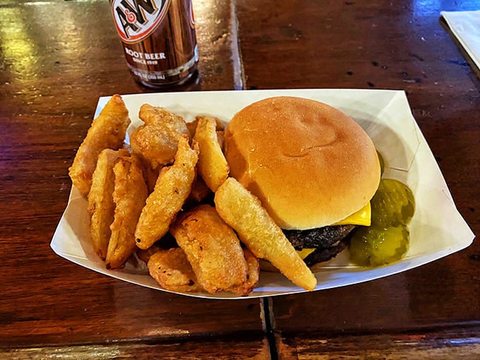 Behold the star of the show: a perfectly grilled cheeseburger with golden fries that would make any fast-food chain weep with inadequacy.