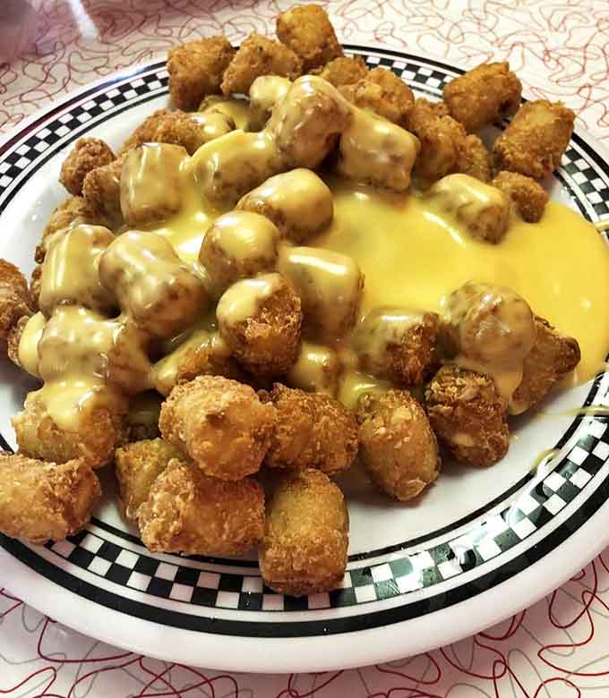 Behold the legendary Horseshoe &ndash; an open-faced monument to excess where cheese sauce cascades over golden tater tots like a dairy Niagara Falls.