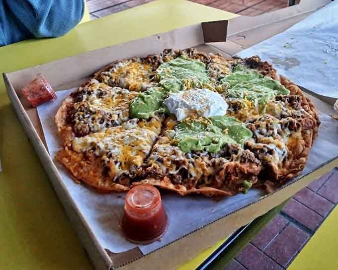 This Mexican pizza isn't confused about its identity—it knows exactly what it is: a glorious disc of melted cheese, seasoned meat, and avocado that defies categorization.