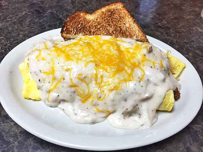 Behold the omelet that launched a thousand food pilgrimages! Draped in country gravy and melted cheese, it's breakfast architecture at its finest.