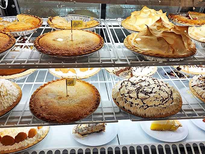 Pie paradise! Each golden crust holds secrets that grandmothers would arm-wrestle for. The meringue peaks have their own weather system.