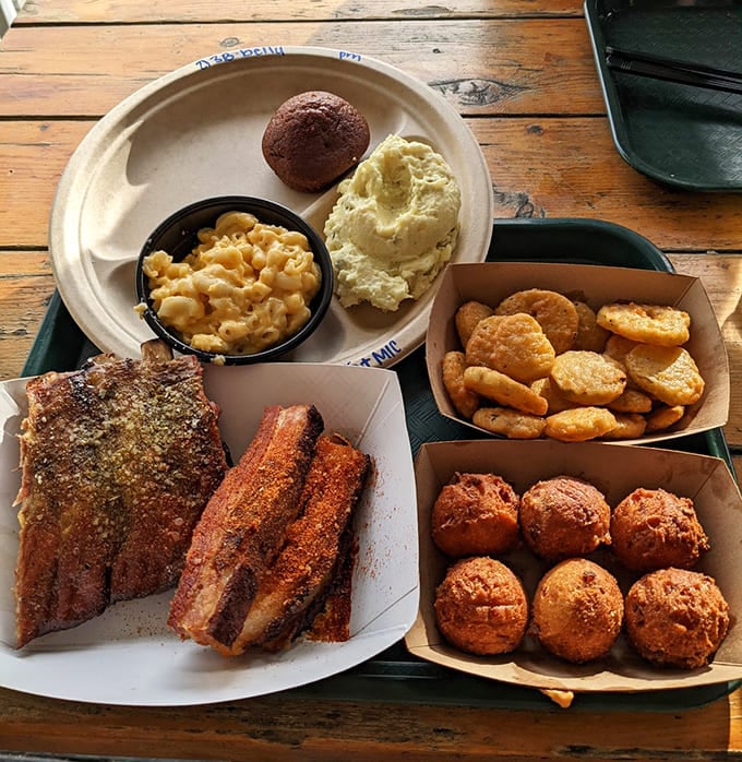 Barbecue platter nirvana – ribs with perfect bark, mac and cheese that's actually cheesy, and hush puppies that would make your Southern grandmother proud.