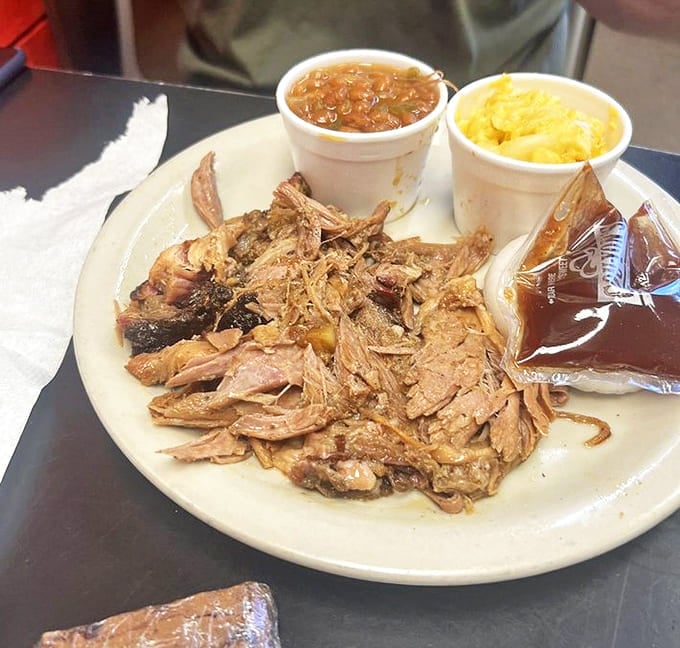 This pulled pork doesn't just fall apart &ndash; it practically surrenders to your fork after hours in the smoker, flanked by beans and mac and cheese.