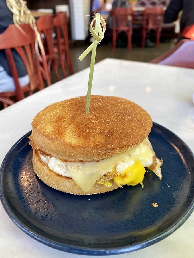 This breakfast sandwich isn't just food&mdash;it's an event. Golden English muffin, melty cheese, and that perfectly runny egg yolk ready for its close-up.