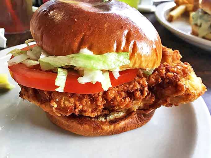 The legendary Hoosier tenderloin in all its golden-fried glory &ndash; a sandwich so magnificent it makes the bun look like it's wearing a too-small hat.