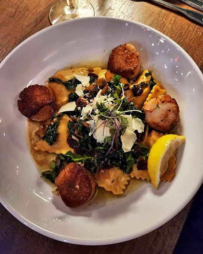 Perfectly seared scallops dance around pasta like culinary celebrities, their golden crusts hiding the buttery treasures within.