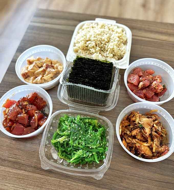 A feast for both eyes and stomach—this spread of various poke styles, seaweed salad, and rice is Hawaii's answer to a perfect meal.
