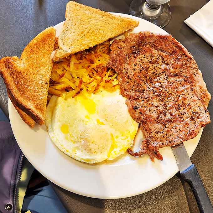 Country ham that's seen just the right amount of skillet time, eggs with sunshine-yellow yolks, and toast ready for serious plate-mopping duty.