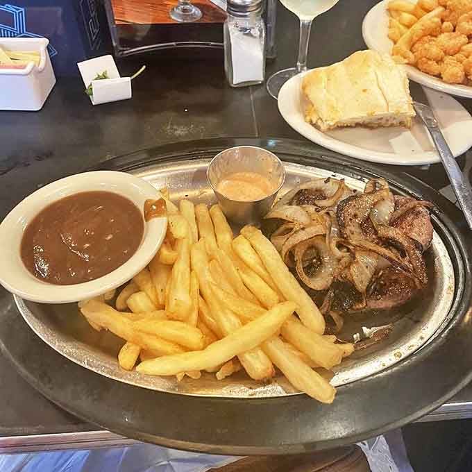 Steak that doesn't need a fancy presentation to make its point. With that gravy, those fries, and that sauce, this plate speaks the universal language of comfort.