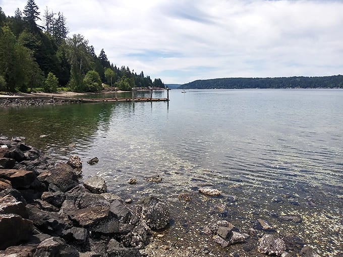 Crystal clear waters lap against the rocky shore, creating nature's own meditation soundtrack that no smartphone app could ever replicate.