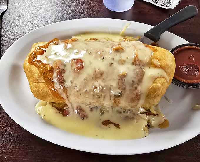 This breakfast burrito isn't just wrapped, it's smothered in a blanket of cheese sauce that says, "Go back to bed after eating me." Worth every nap-inducing bite.