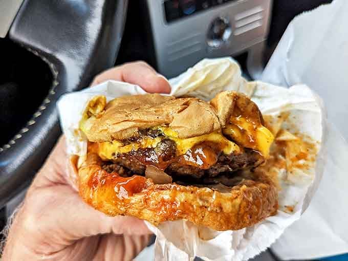 Behold the cheeseburger in its natural habitat&mdash;juicy, messy, and demanding both hands. This isn't Instagram food; it's honest-to-goodness satisfaction wrapped in paper.