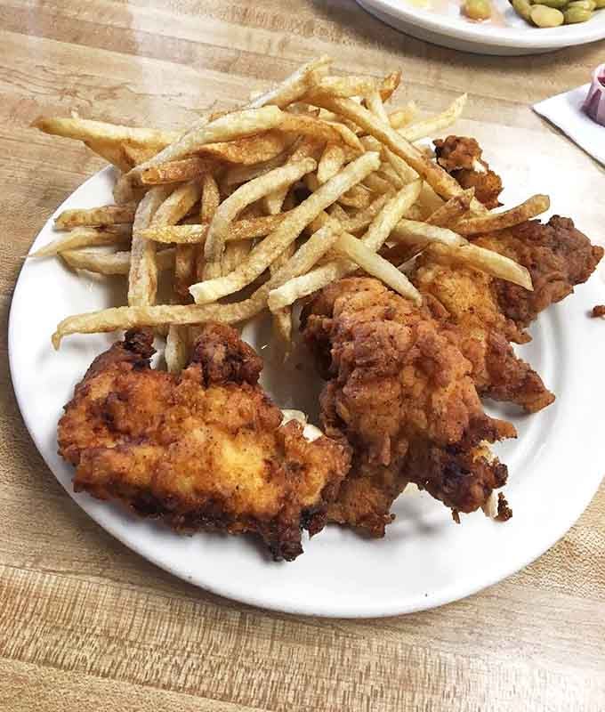 Golden-fried chicken that crackles with each bite, paired with fries so perfectly crisp they deserve their own fan club.