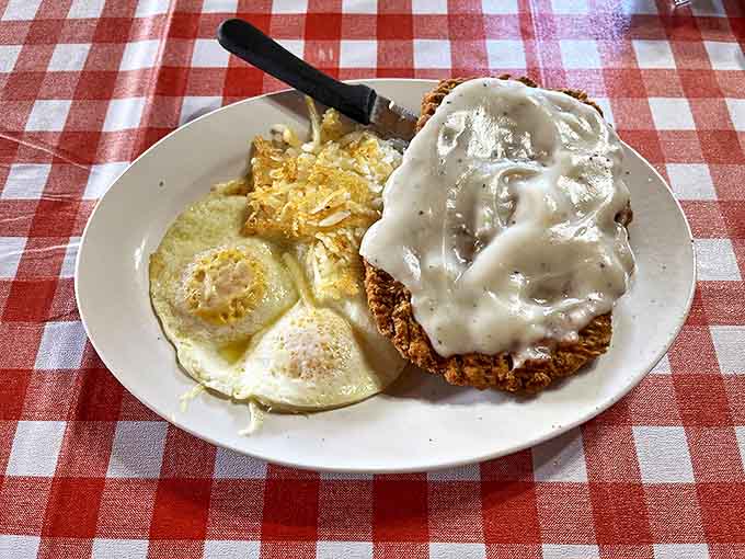 Behold the chicken fried steak – a crispy-coated masterpiece smothered in gravy that could make a vegetarian question their life choices.