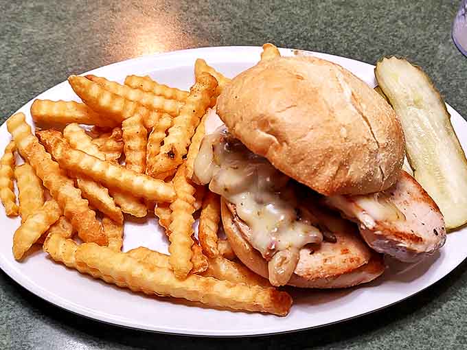A sandwich that requires both hands and possibly a strategy session. Those crinkle-cut fries are the supporting actors who deserve their own Oscar.
