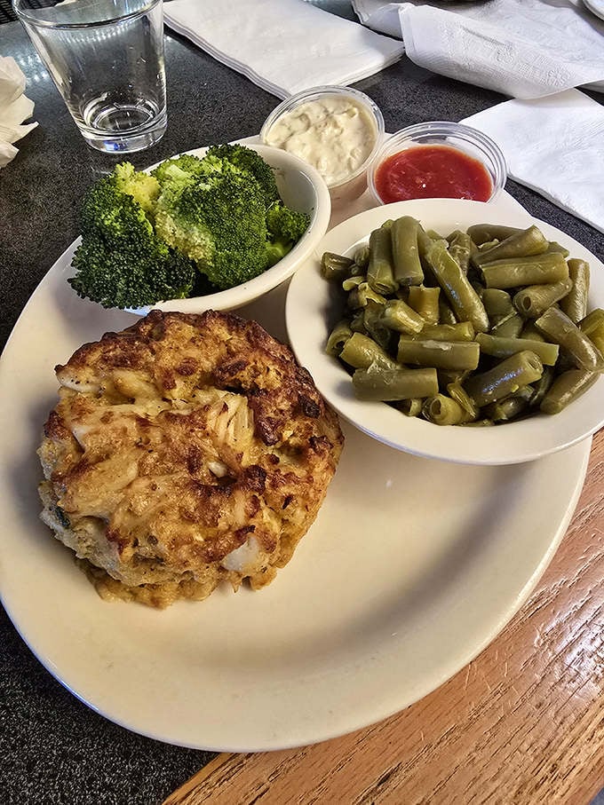 The star of the show: a golden-brown crab cake with barely enough filler to remind you it's not just a pile of delicious crab meat.