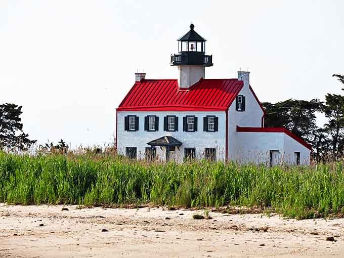 The East Point Lighthouse stands sentinel over the bay, a crimson-roofed beacon guiding both ships and weekend photographers for generations.