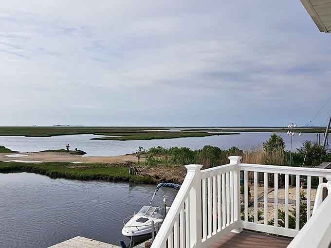 Nature's front porch: where marsh grasses dance with the breeze and small boats wait patiently for their next journey across the glassy waters.