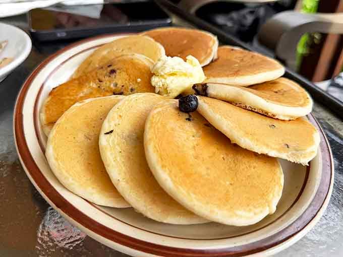 These golden pancakes aren't just breakfast &ndash; they're edible sunshine stacked high enough to cast a shadow across your coffee cup.