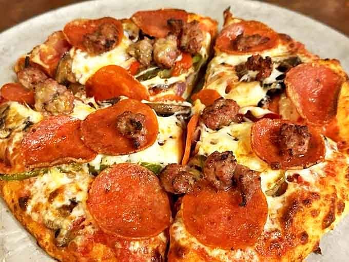 This isn't just pizza—it's a meaty masterpiece of pepperoni and sausage performing a perfect duet atop a canvas of melted cheese and crispy crust.