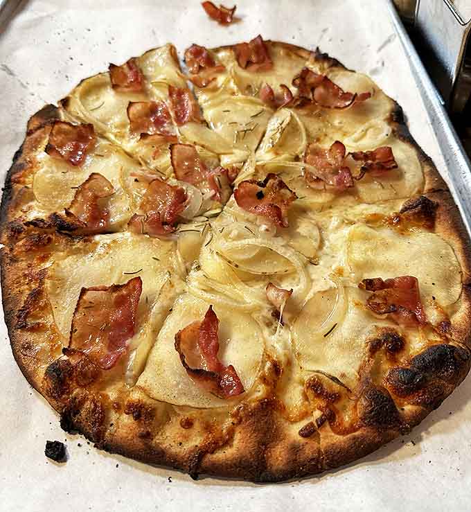 Potato and bacon pizza that makes carb-counting seem like cruel and unusual punishment. Worth every delicious, guilt-free bite.
