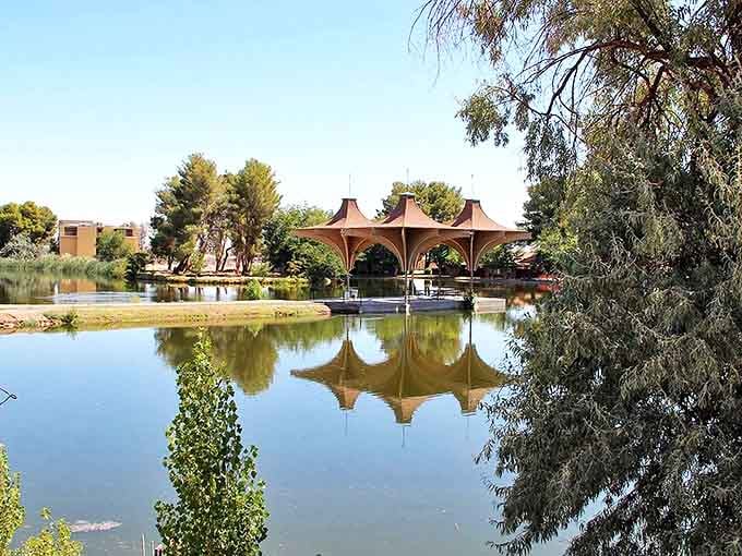 A peaceful park pavilion reflects in still waters at California City's waterfront. Nature's mirror showing off California's quieter side.