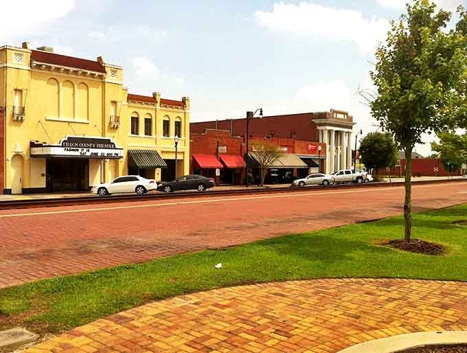 Historic brick-paved Main Street in Dillon showcases colorful storefronts and small-town charm under clear Carolina skies.
