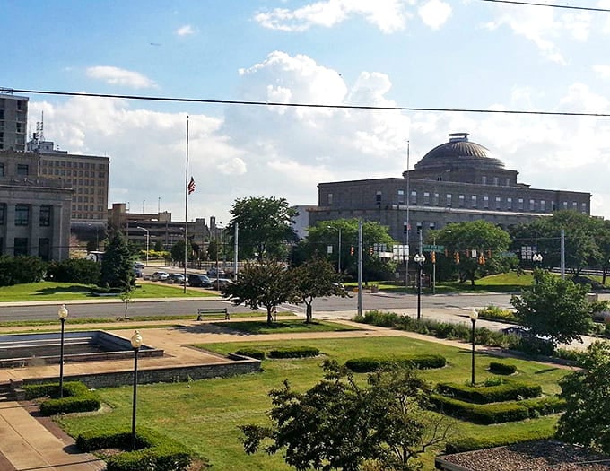 A lovely view of Gary&rsquo;s civic architecture and green spaces, where classic stone buildings meet wide, bright Midwestern summer skies.
